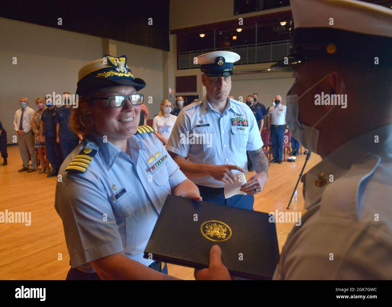 Capt. Amy Beach, commander of Coast Guard Sector Ohio Valley, hands a ...