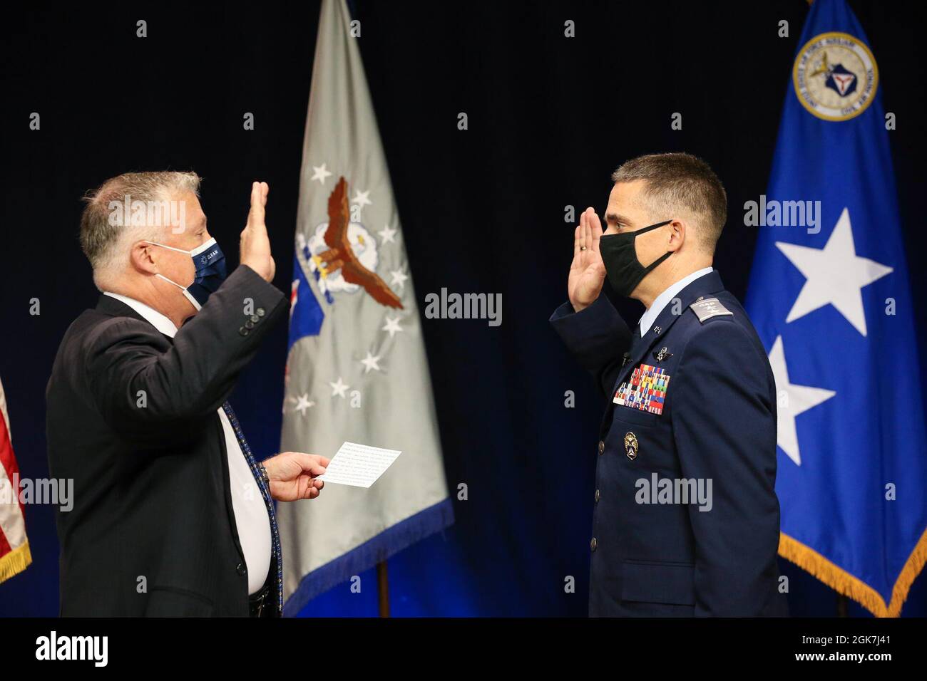 Retired U.S. Air Force Lt. Gen. Kevin McLaughlin administers the oath ...