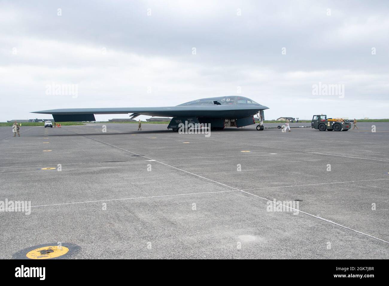 Airmen assigned to the 131st and 509th Maintenance Squadrons tow a B-2 ...