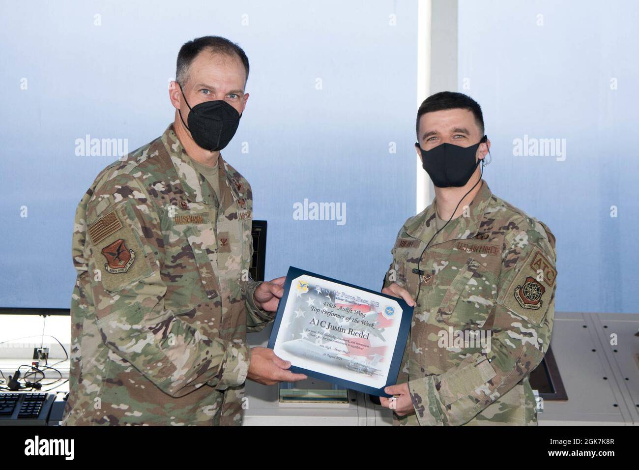 Col. Matt Husemann, left, 436th Airlift Wing commander, presents Airman ...