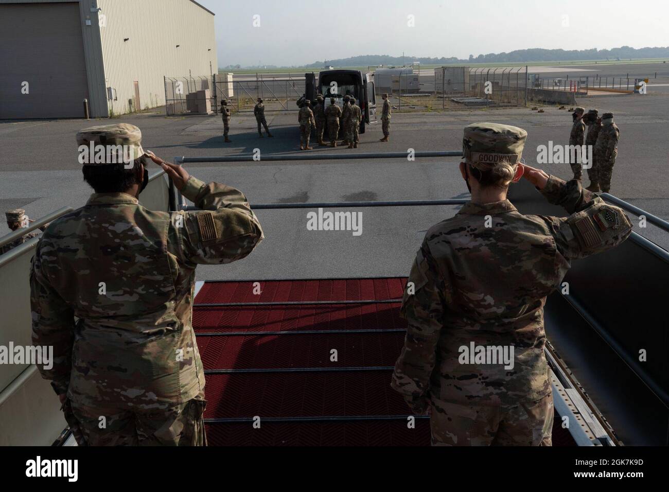 Staff Sgt. Parish Thacker and Tech. Sgt. Naomi Goodwin render a salute ...