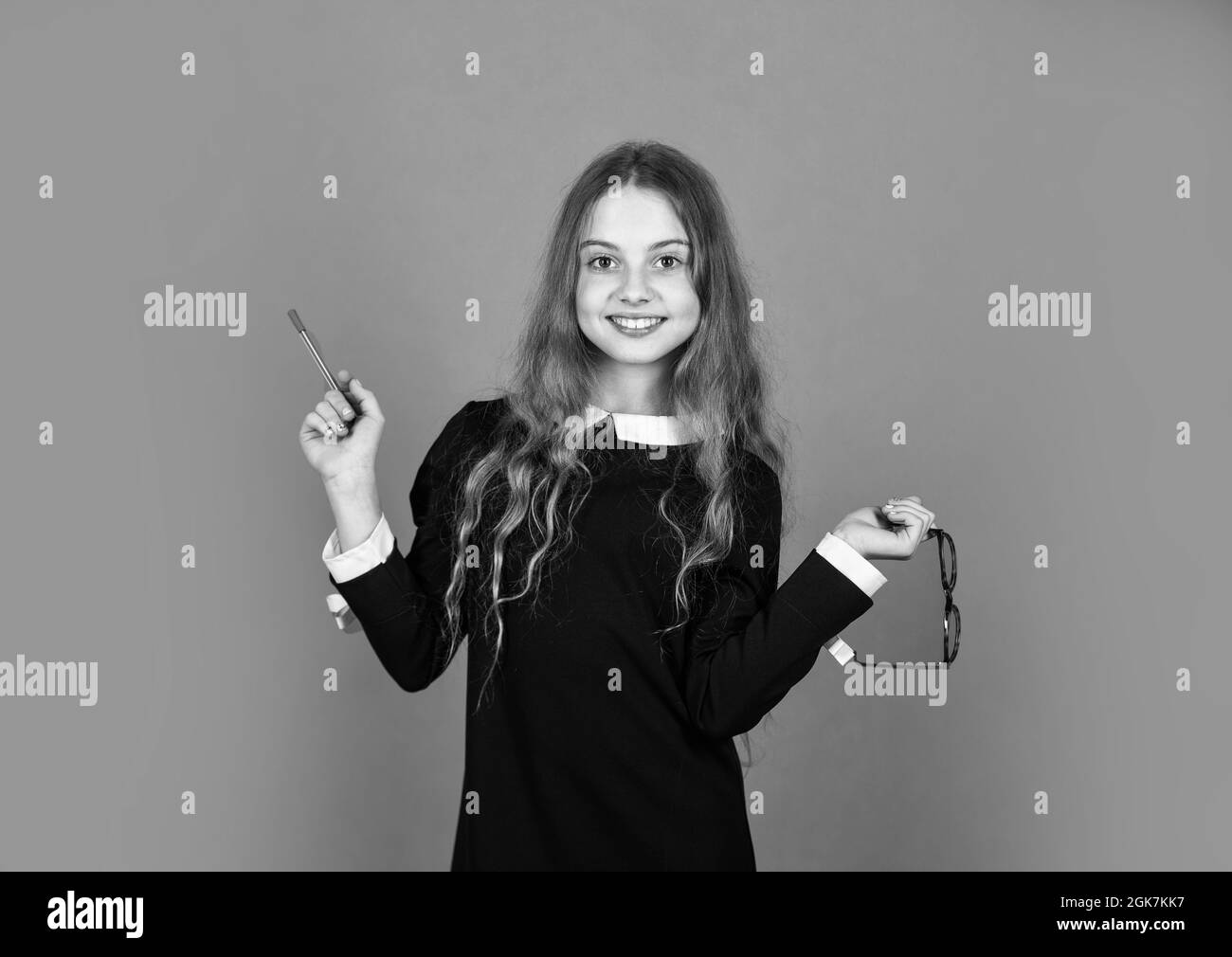 Cute genius. Girl genius brown background. Genius little child hold pen ...