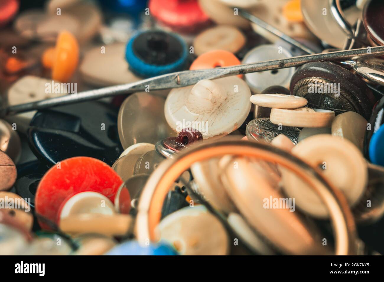 Selective focus shot of colorful buttons of different sizes and sewing ...