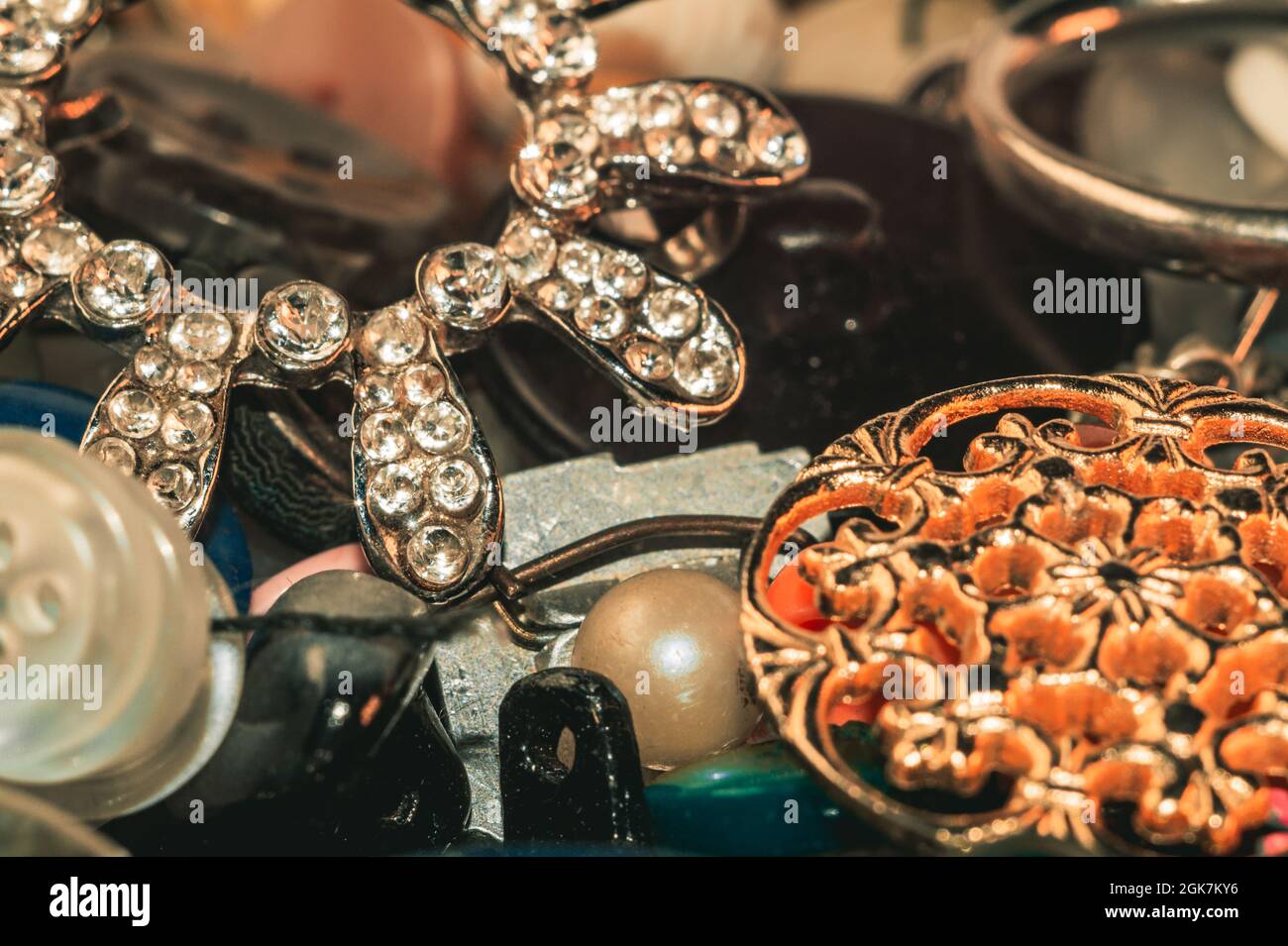 Selective focus shot of colorful buttons of different sizes and sewing ...