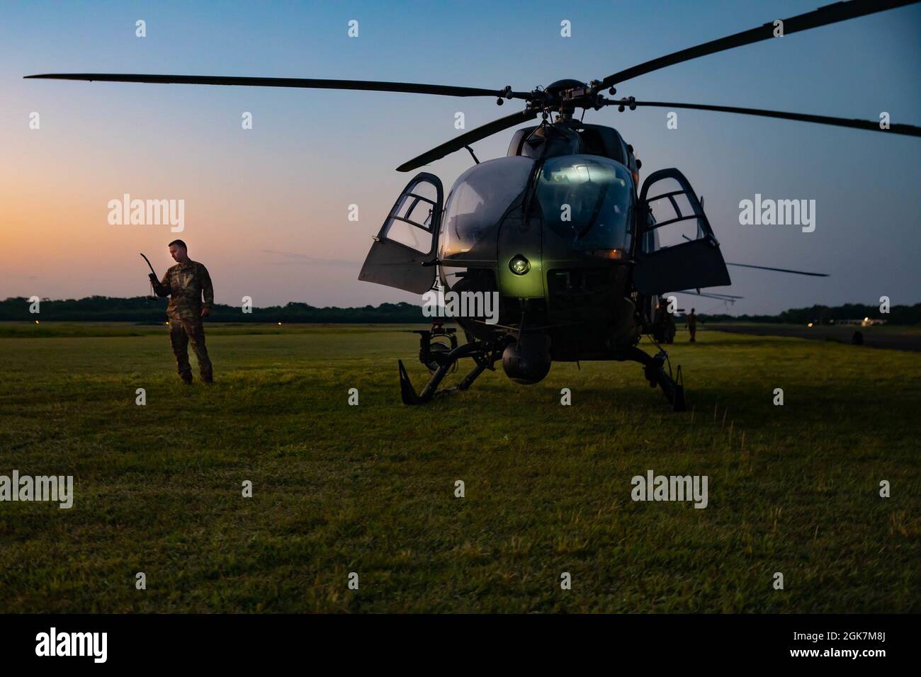 Chief Warrant Officer two (CW2) Jean Rodriguez stands next to the UH-72 ...