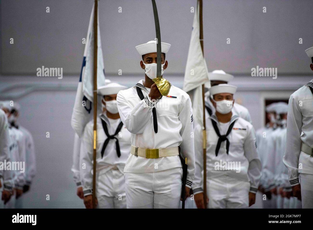 A graduation Sailor presents arms while mustering his division all ...