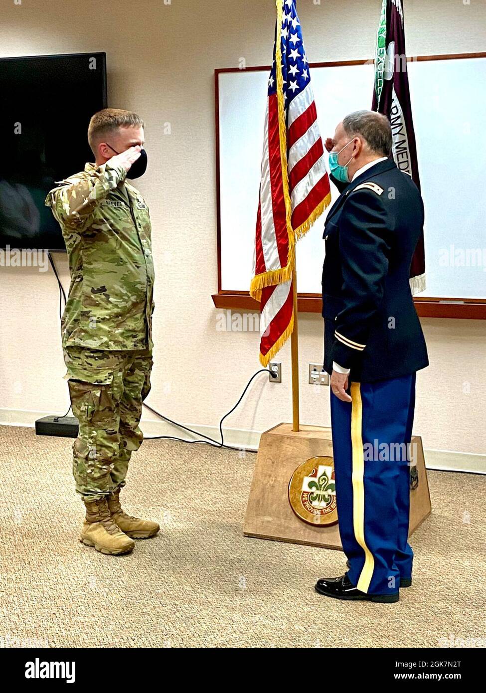 Staff Sgt. Cameron Reeves (left) renders the first salute to newly ...