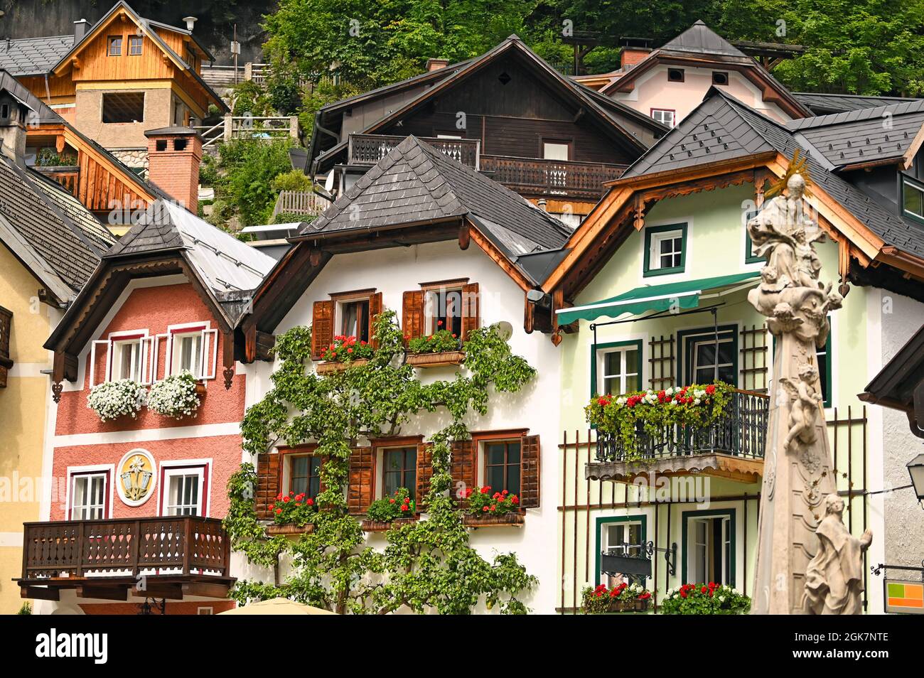 Old houses with flowers on the terraces in Hallstatt village Austria ...