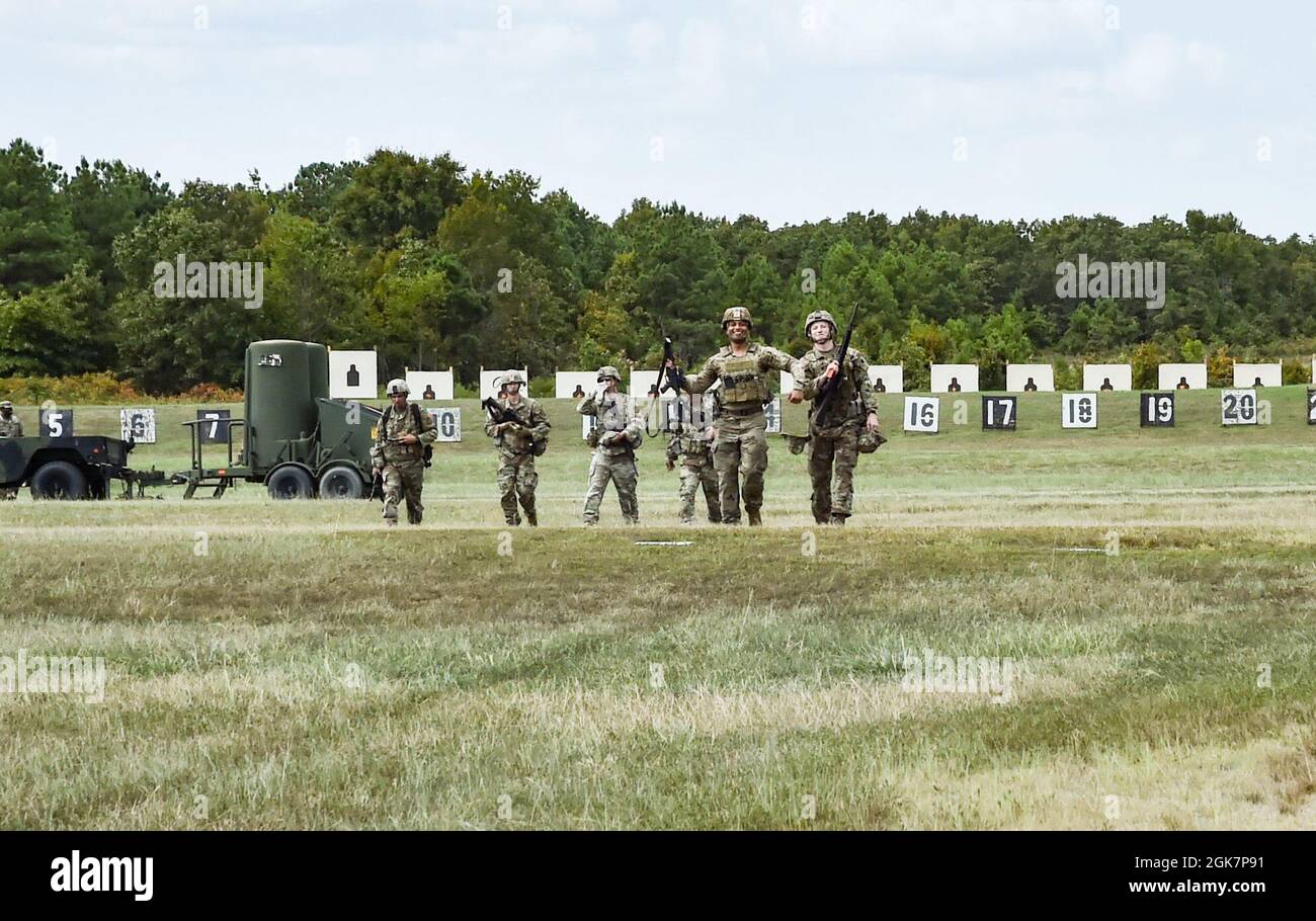 Two soldiers smile while walking to the 300 yard berm during the ...