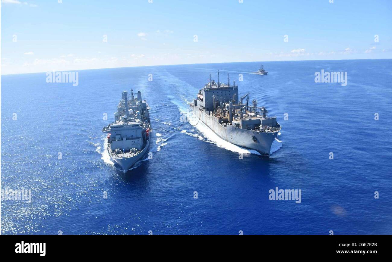 EAST CHINA SEA -- USNS Alan Shepard (T-AKE 3), left, conducts an ...