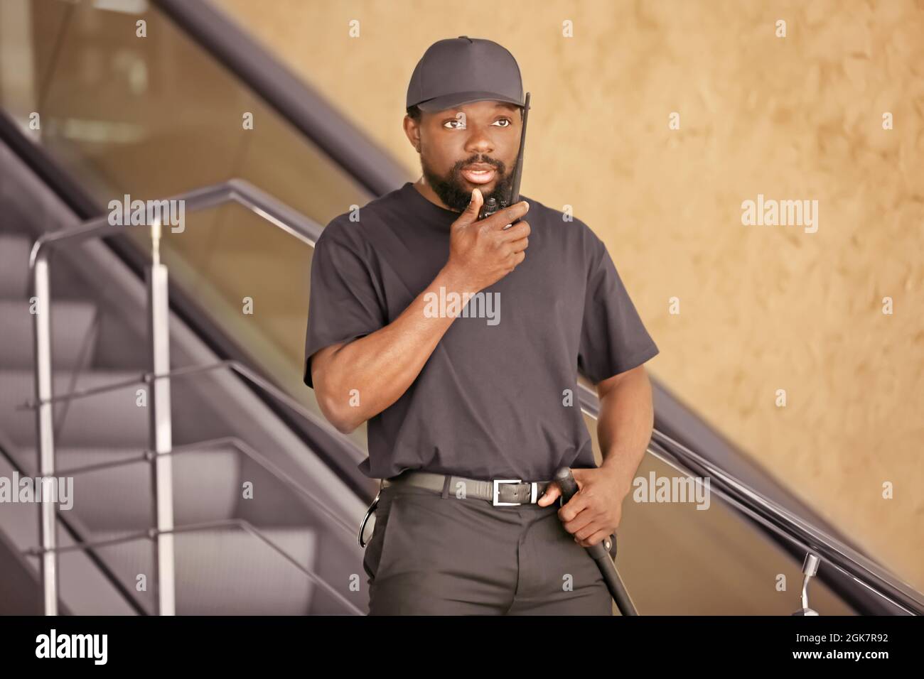 Male security guard using portable radio transmitter indoors Stock ...