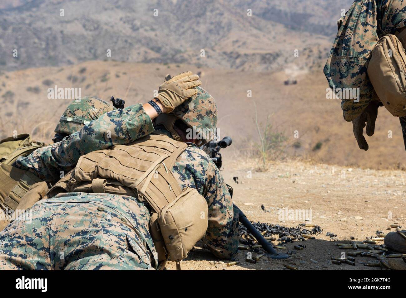 U.S. Marines with Marine Air Control Squadron 1 (MACS-1) fire an M240B ...