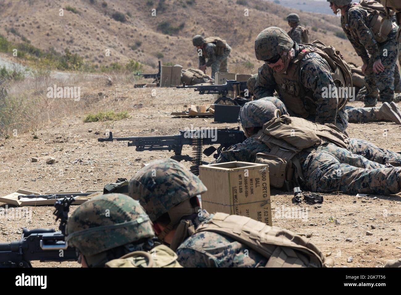 U.S. Marines with Marine Air Control Squadron 1 (MACS-1) fire an M240B ...