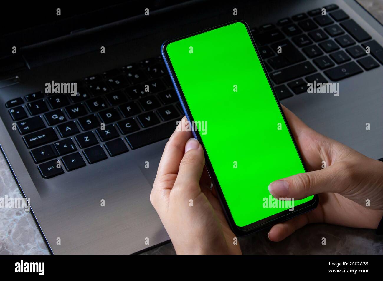 Woman hand holding green screen mobile phone Stock Photo - Alamy