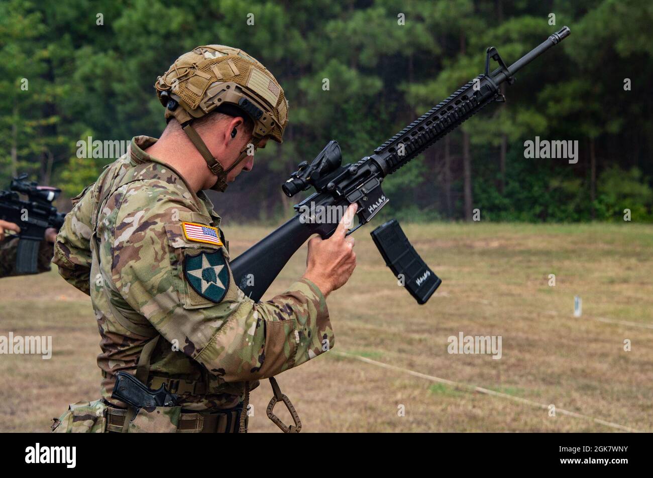Capt. Marshall Halas, Michigan National Guard, fires rapidly during the ...