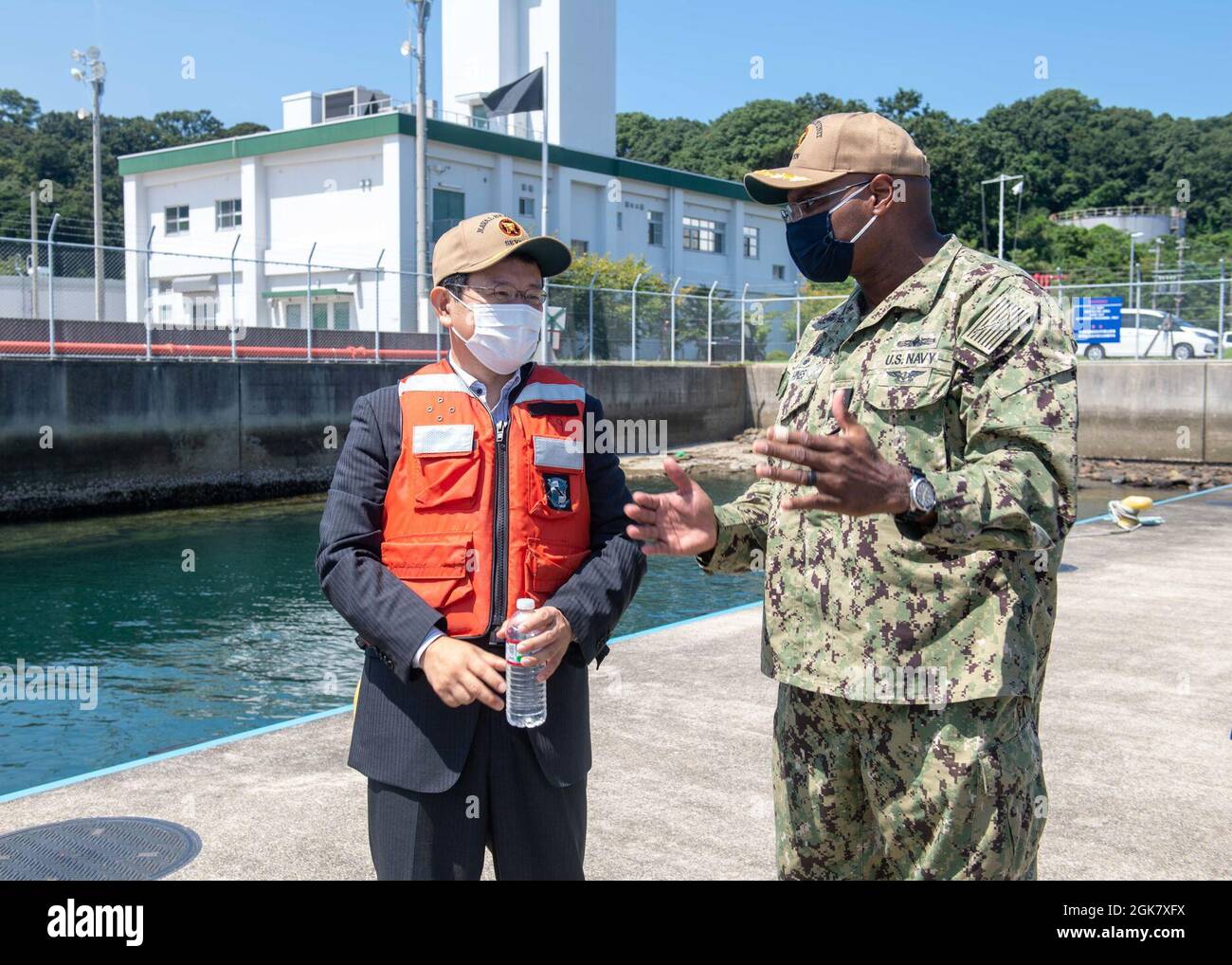 Cmdr. Wilbur Hines, commanding officer of Naval Beach Unit 7, meets ...