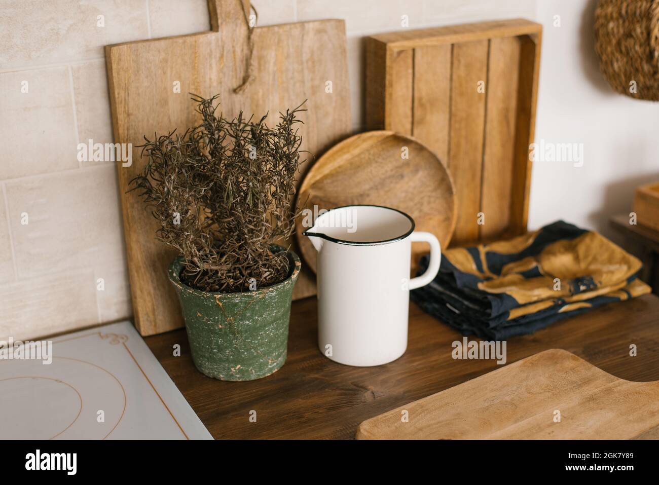 White metal milk jug, potted flowers, cutting board and kitchen decor ...