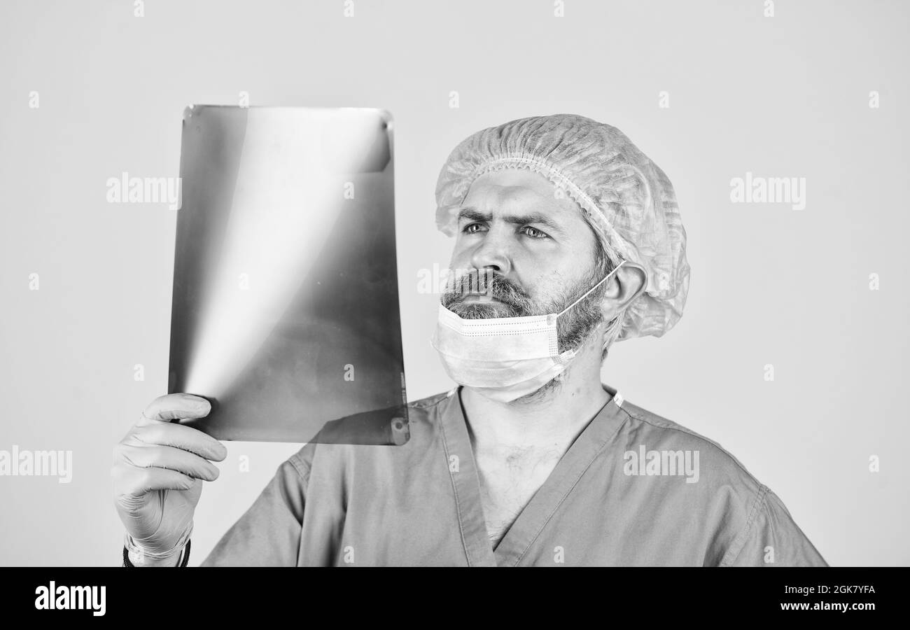 surgeon doctor examines radiographical snapshot. x-raying of vertebra ...