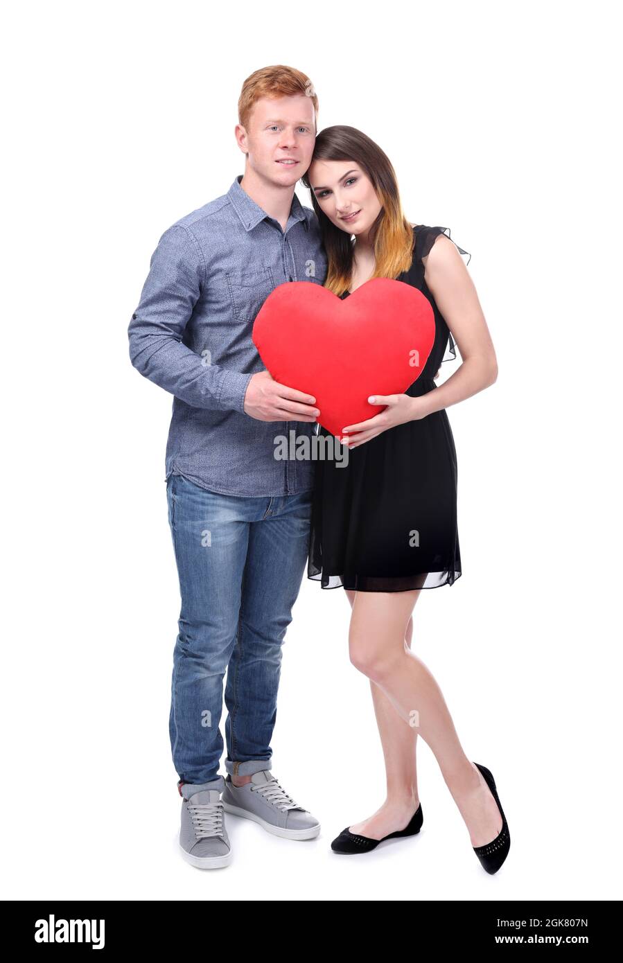 Lovely couple holding red heart on white background Stock Photo - Alamy
