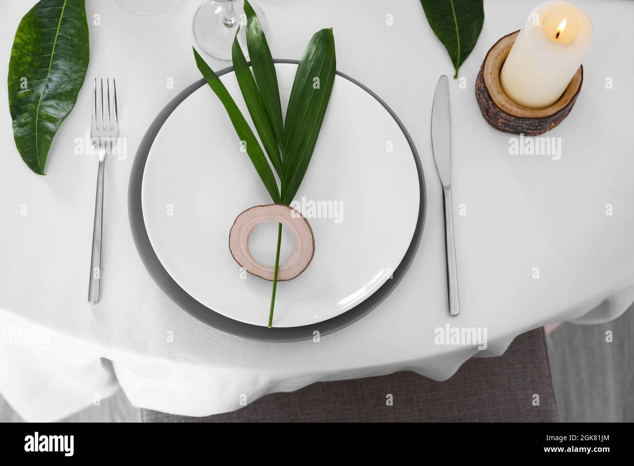 Beautiful table setting with green tropical leaves Stock Photo - Alamy