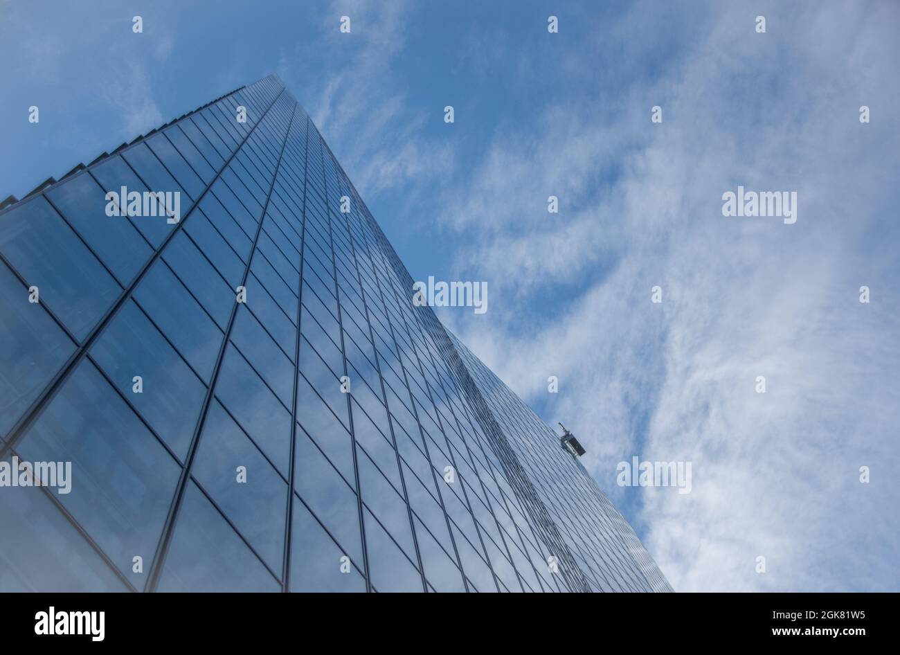 Blue Sky reflected in the glass windows of a skyscraper in Tokyo's CBD ...
