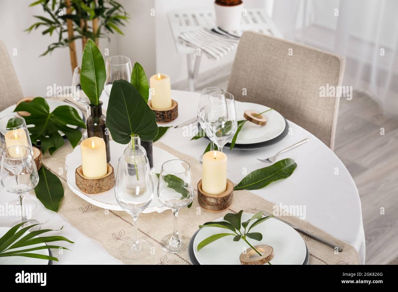Beautiful table setting with green tropical leaves Stock Photo - Alamy
