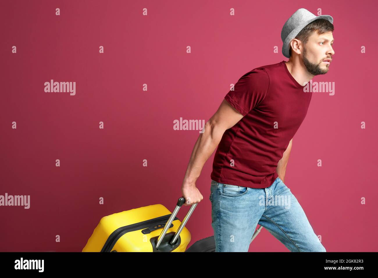 Man with overweight luggage on colorful background Stock Photo - Alamy