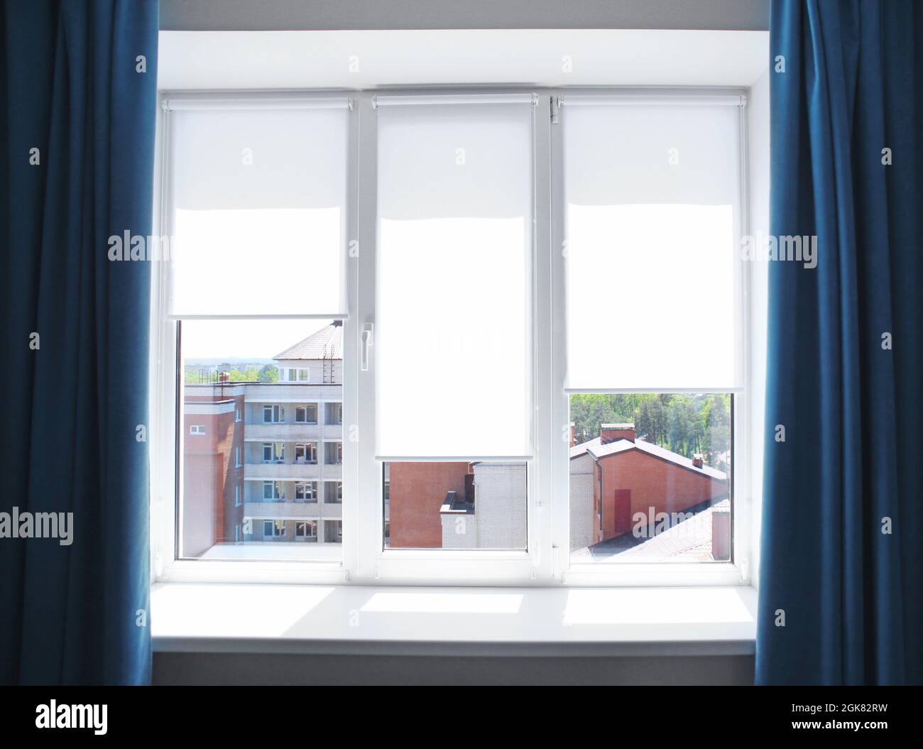 Modern white plastic window with roller blinds in flat Stock Photo - Alamy