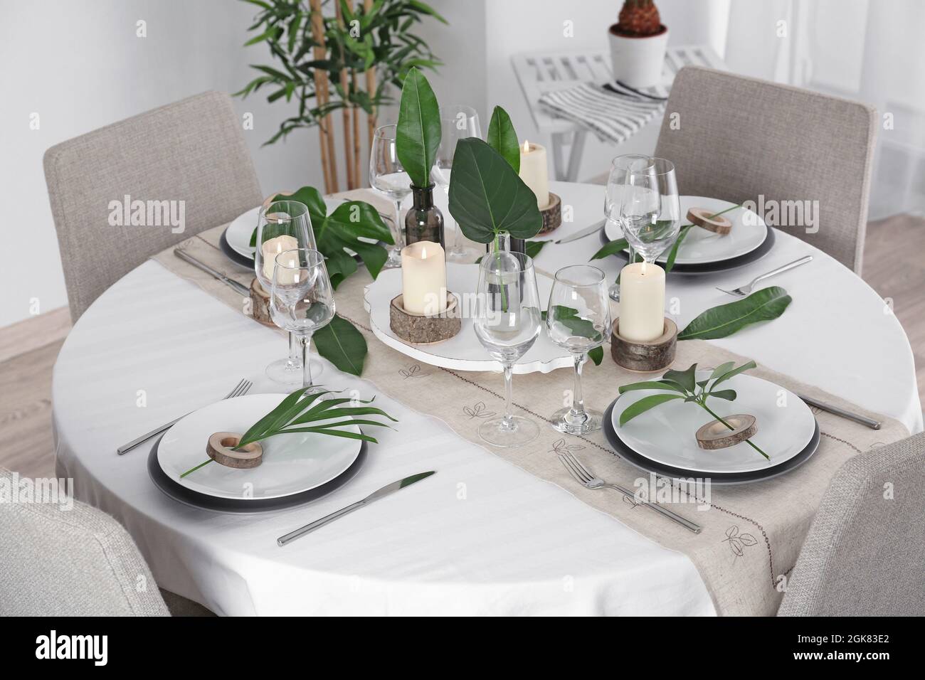 Beautiful table setting with green tropical leaves Stock Photo - Alamy