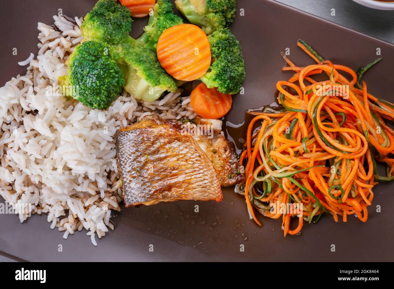 Plate with delicious fish, sauce, rice and vegetables, closeup Stock ...