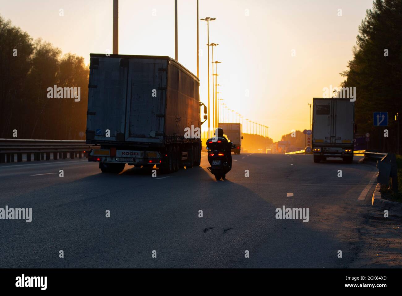 Sunset on the highway. The sun is setting over the highway. Loaded ...