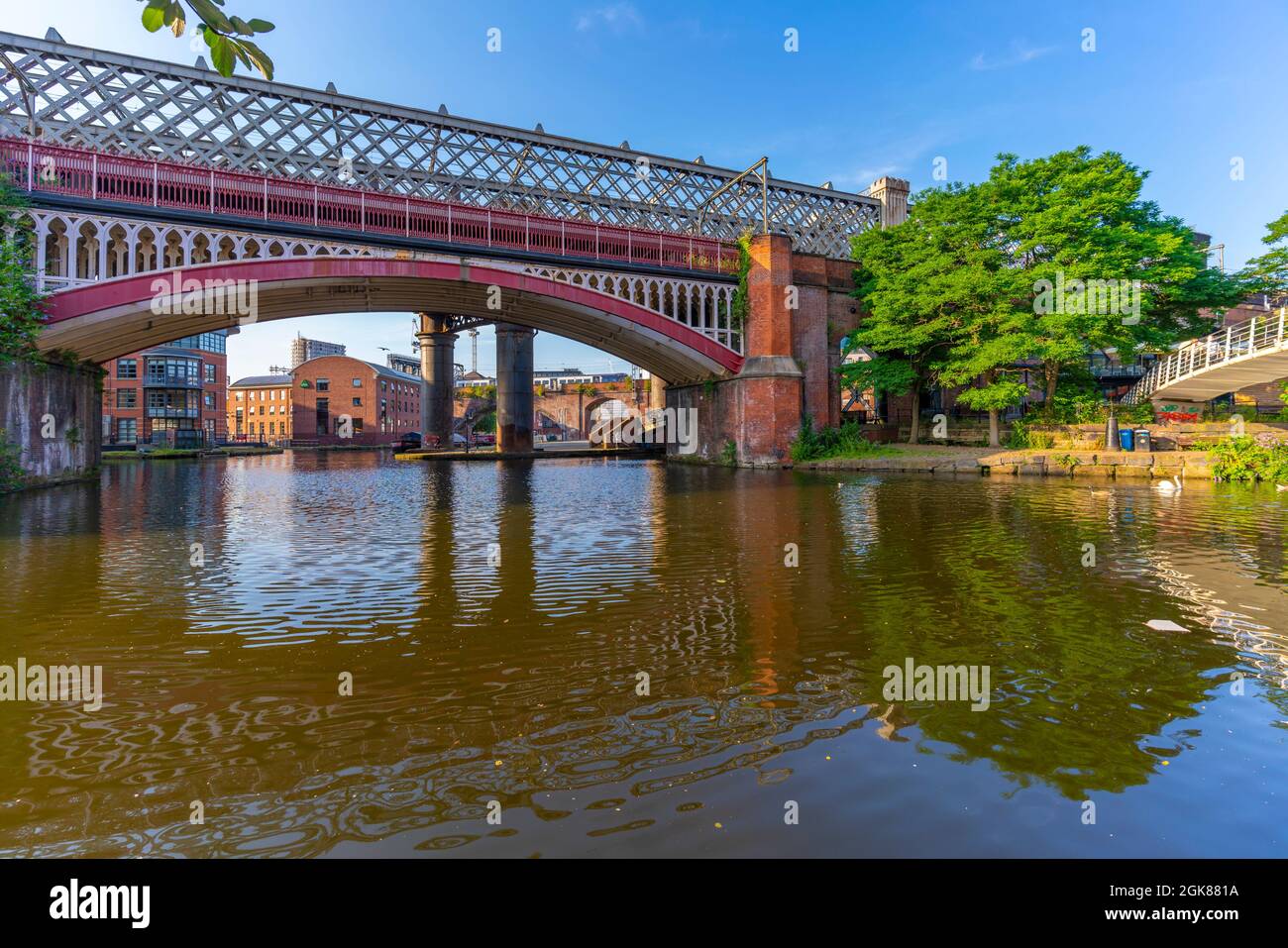 View of tram and train bridges reflecting in Castlefield Canal ...