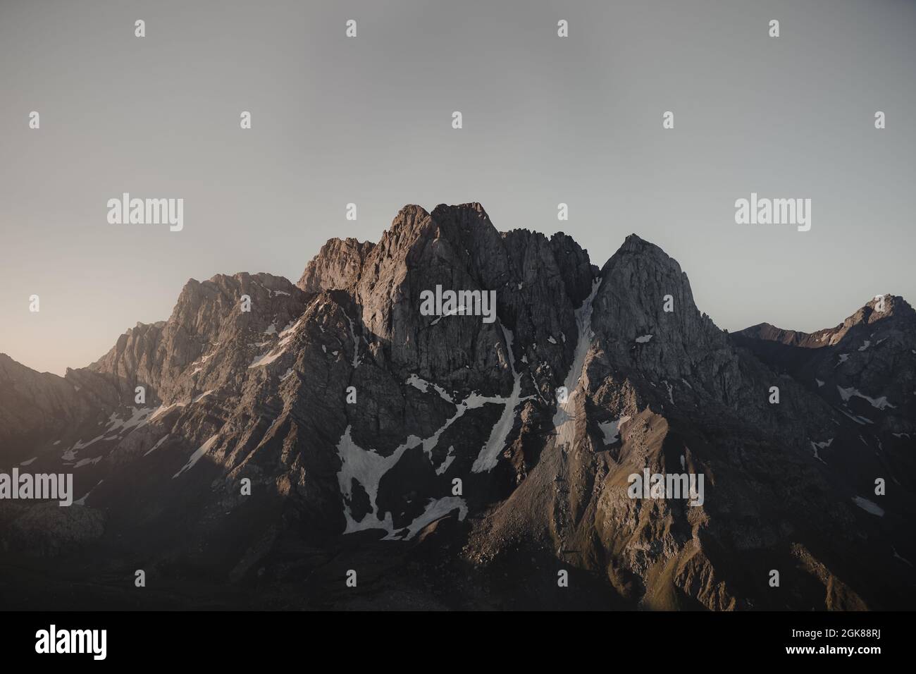 Beautiful view of the mountains covered in snow on a gloomy day Stock Photo - Alamy