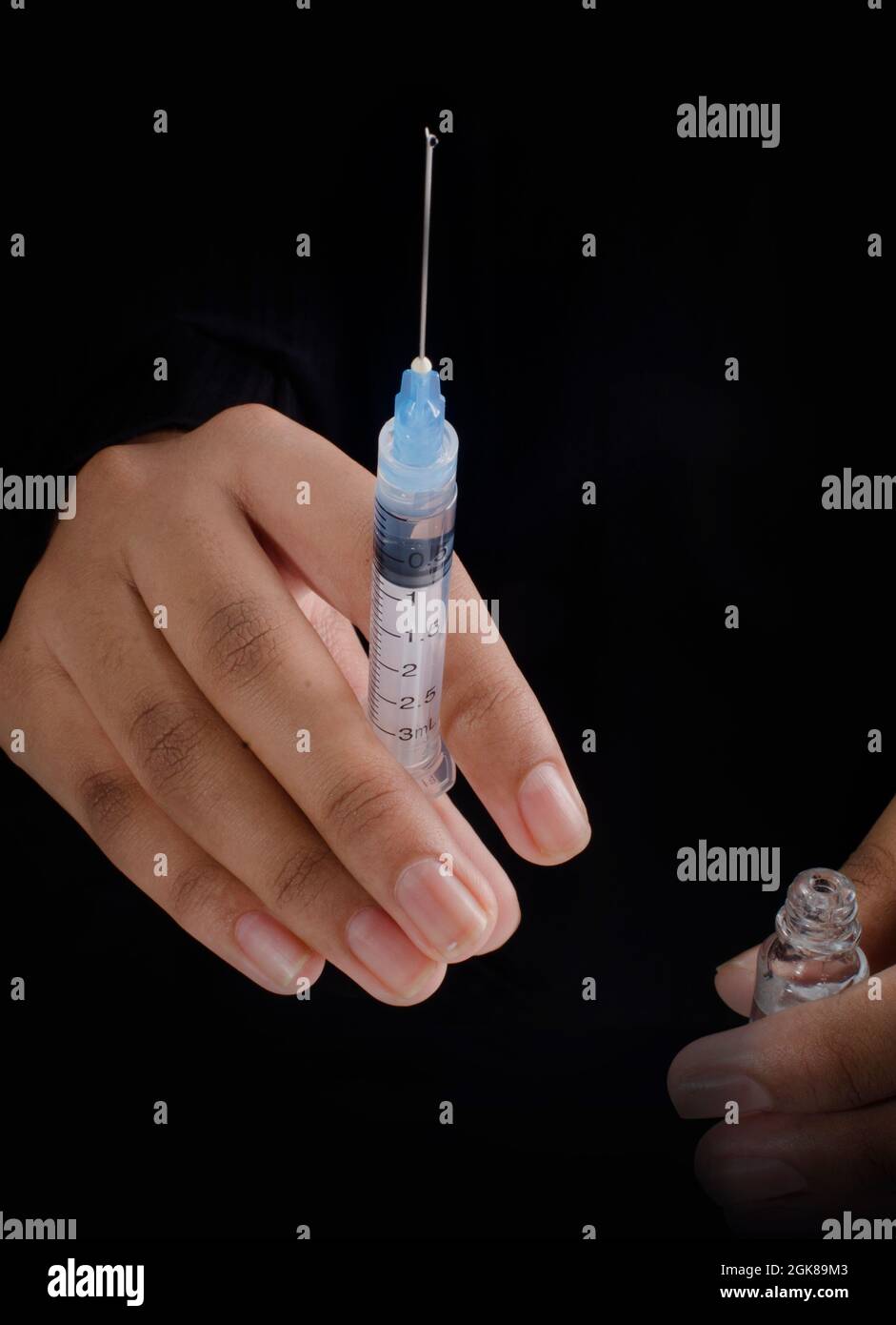 A Female Nurse Holding An Injection In Hand Stock Photo - Alamy