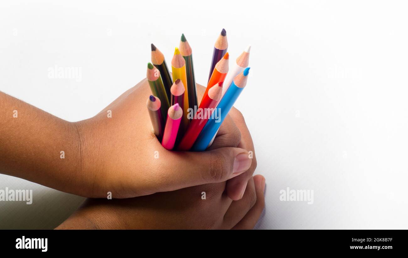 Young Girl holding Rainbow Colored Pencil set in hand. Education ...
