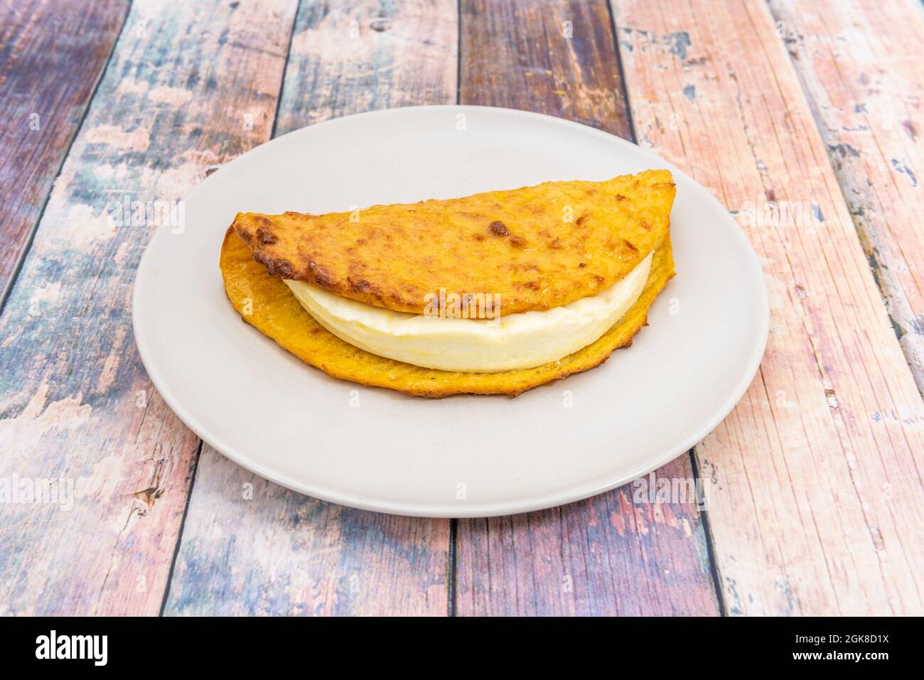 Corn cachapa filled with a good piece of melted fresh cheese ...