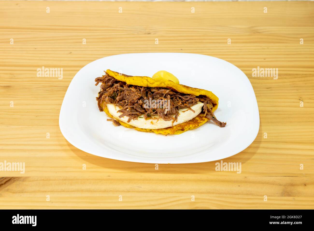 Venezuelan corn cachapa with shredded meat, fresh cheese and a nut of ...