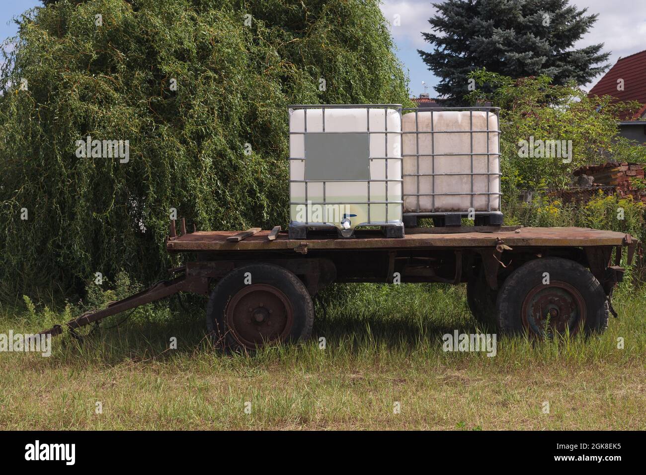 Horizontal view of two white big plastic containers of water on cargo ...