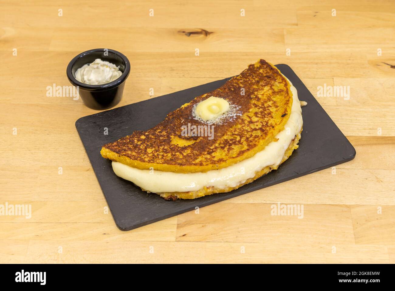 Venezuelan corn cachapa stuffed with melted fresh cheese and butter on ...