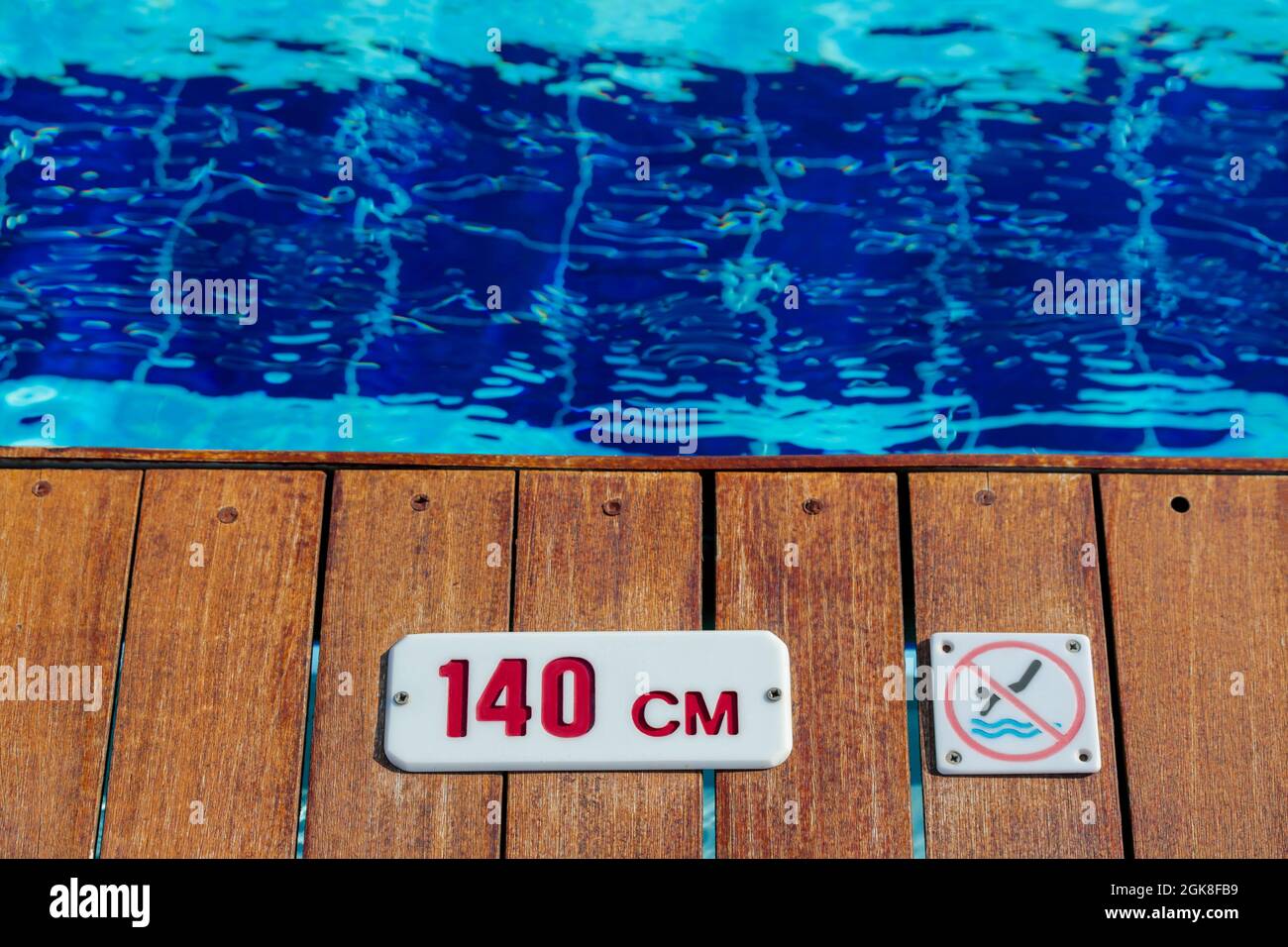 no diving and depth sign warning at swimming pool edge with copy space ...
