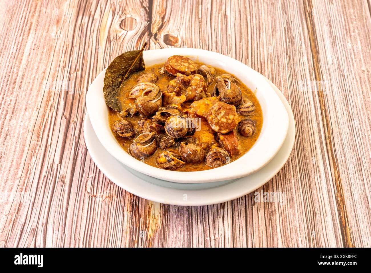 Popular Spanish snail stew with chorizo recipe served in a tapas ...