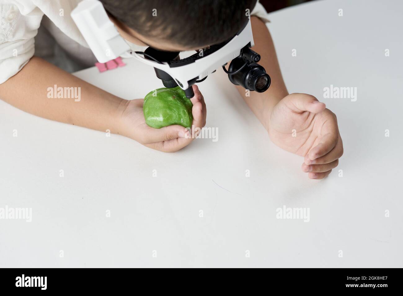 A boy in head magnifying glasses headset learning Incredible chemistry ...