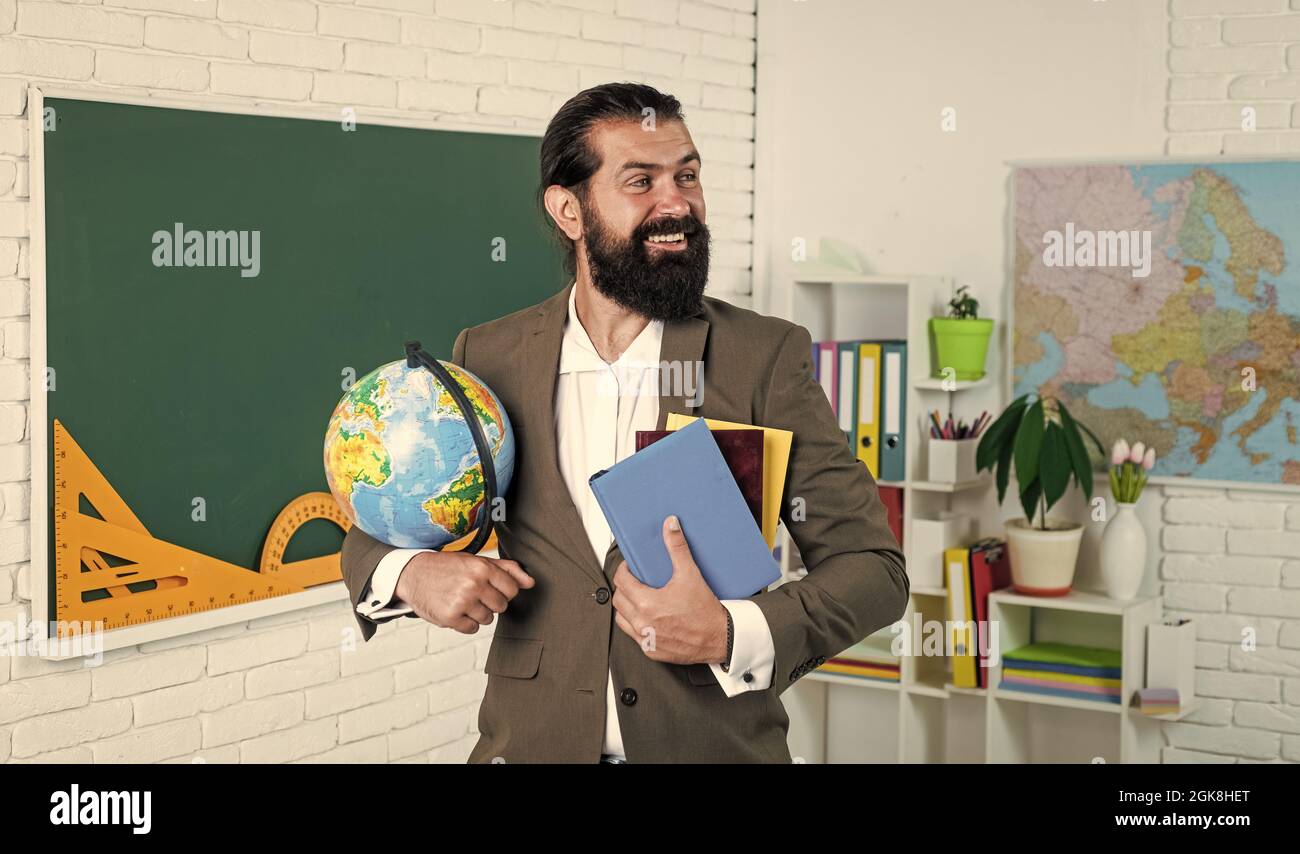 Time to learn more. male student in school classroom while lesson. pass ...