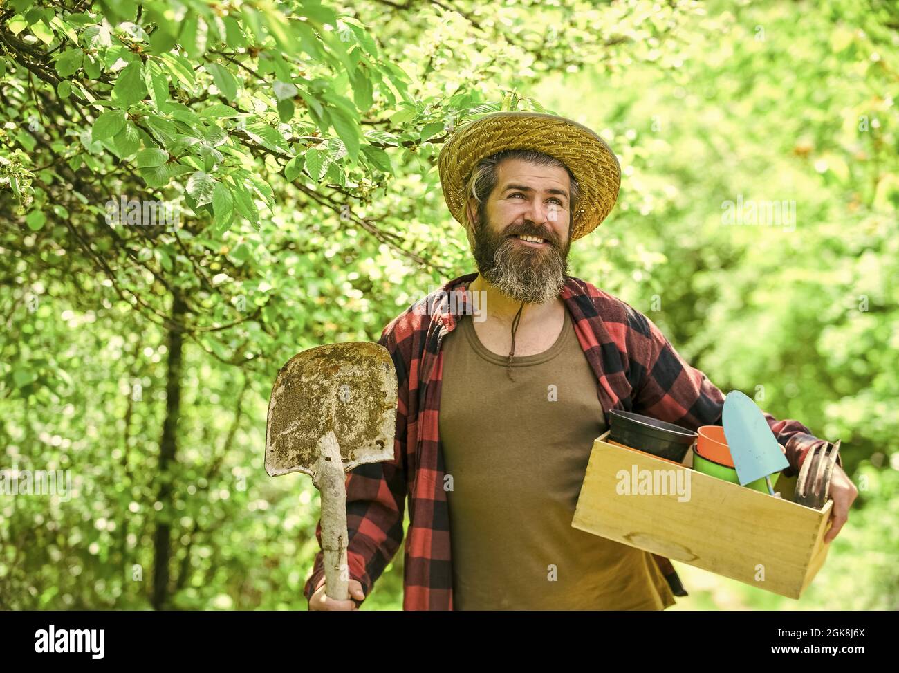 Man bearded hipster collecting harvest. Ranch man. Organic farm. Garden ...