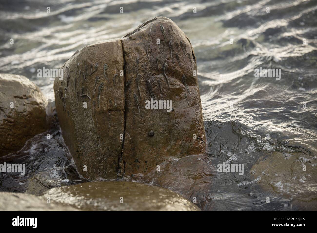 From above of slippery wet rock washed by transparent water of river in ...