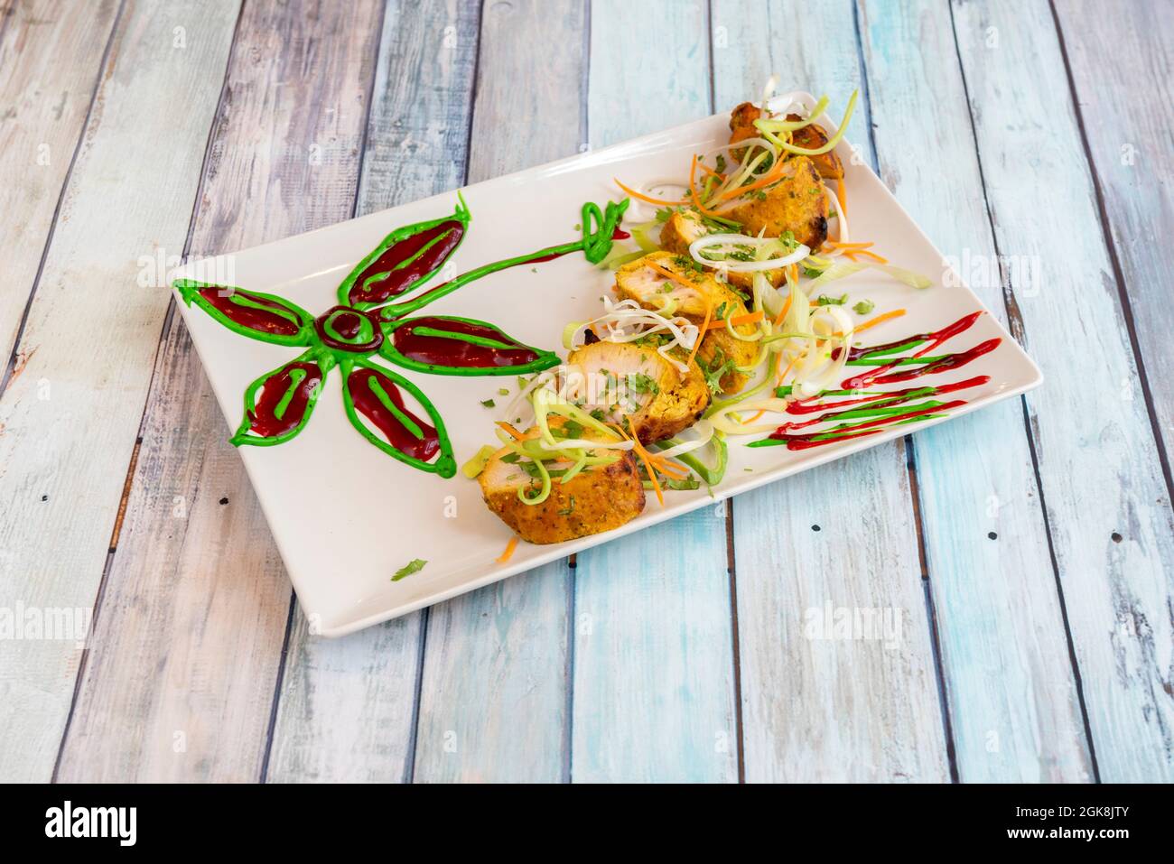 Pakistani tikka recipe chicken skewer with vegetables and plate ...