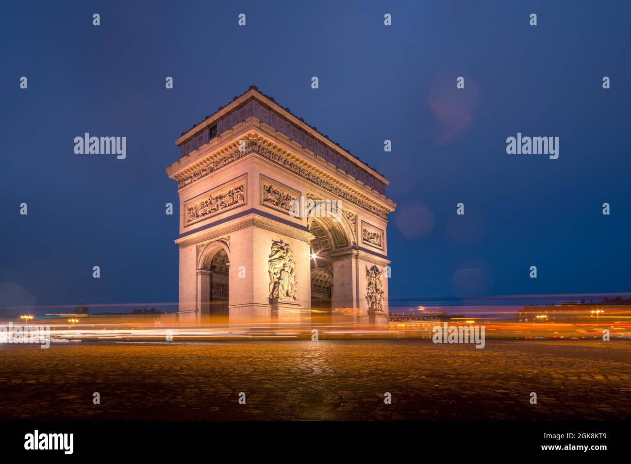 Old stone arch with ornament and statues against square under blue sky ...