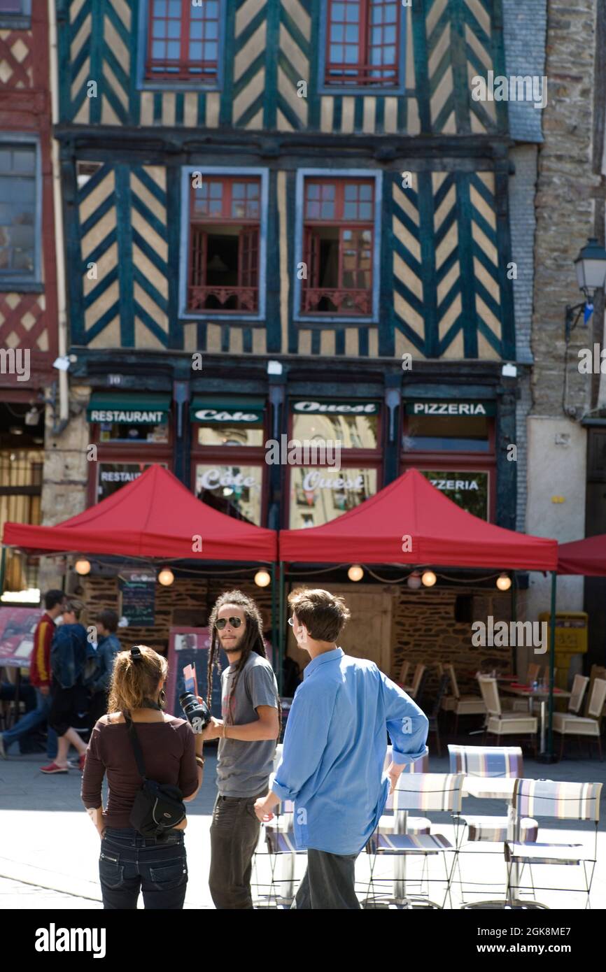 Three young people enjoy the sun in Place Sainte-Anne, Rennes, Brittany ...