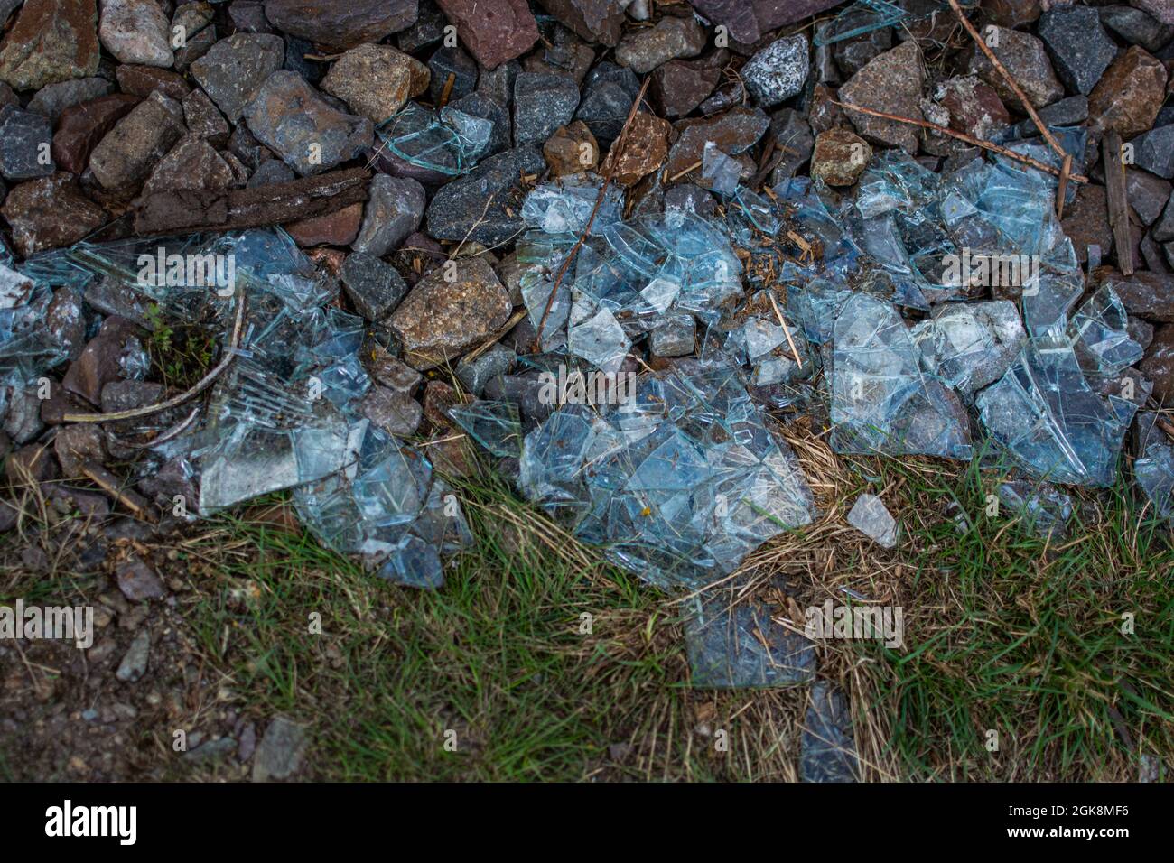 shards of broken glass on stones Stock Photo - Alamy