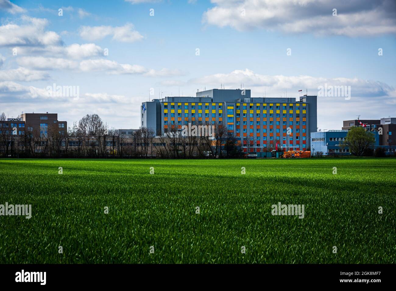 Building behind field of green grass Stock Photo - Alamy